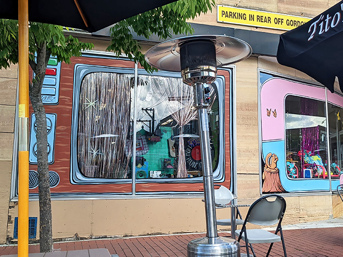 The colorful storefront of Global Thrift beckons like a siren song to bargain hunters. Those retro-styled window displays are practically performance art.