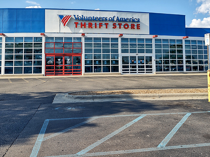 The bright blue exterior of Volunteers of America in Westland stands like a beacon for bargain hunters, promising treasures within its expansive walls.