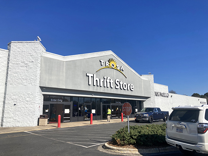 The unassuming exterior of TROSA Thrift Store stands like a temple to thriftiness, promising treasure hunts that would make Indiana Jones jealous. 
