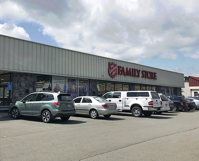 The unassuming exterior of treasure-hunting paradise – where bargain dreams come true behind that stone facade and practical signage.