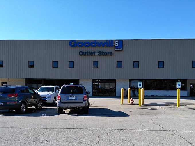 The unmistakable blue and beige exterior of the Goodwill Outlet Store stands like a treasure chest waiting to be opened by bargain hunters.