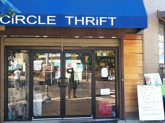 The iconic blue awning of Circle Thrift beckons like a beacon to bargain hunters, promising treasures behind those glass doors that your wallet will thank you for.