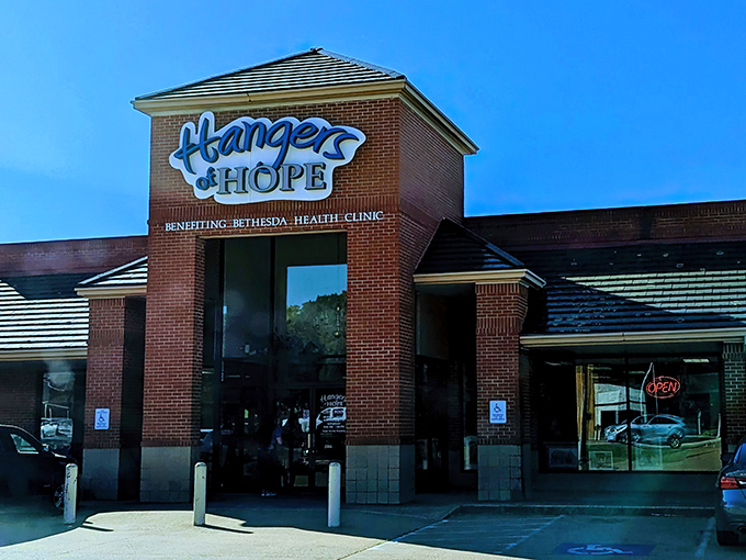 The bright blue Hangers of Hope sign against brick promises more than just retail therapy&mdash;it's shopping with a side of soul.