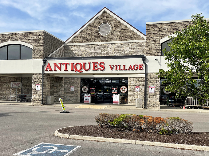 The stone facade of Antiques Village welcomes treasure hunters with its bold red signage—a portal to yesterday that promises discoveries around every corner.