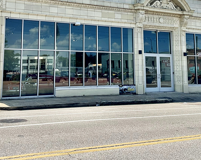 The Edge Motor Museum's elegant fa&ccedil;ade in Memphis blends historic architecture with modern glass, like a tailored suit waiting for automotive enthusiasts to step inside.