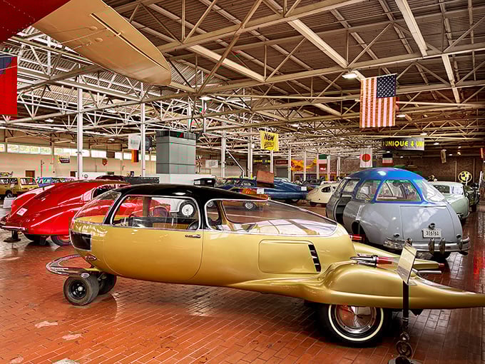 Golden automotive dreams float through this industrial cathedral where transportation history comes alive.