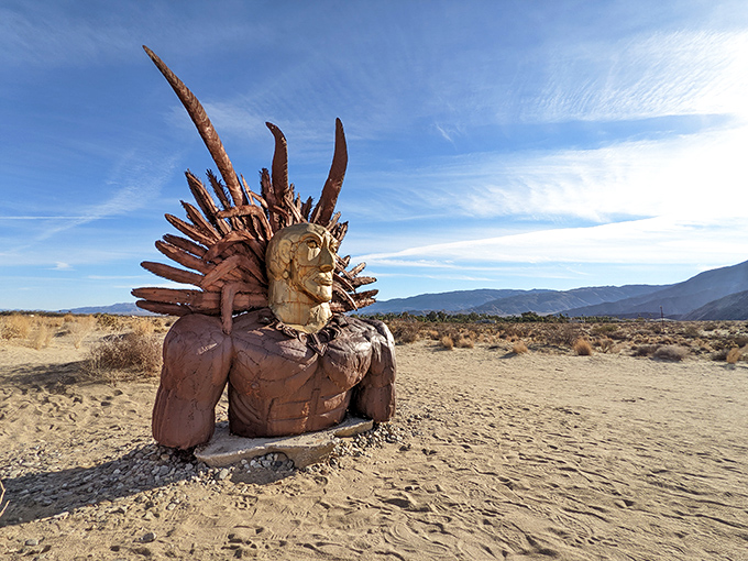 A regal metal guardian emerges from the desert floor, his spiky crown catching the sunlight like nature's own Instagram filter.