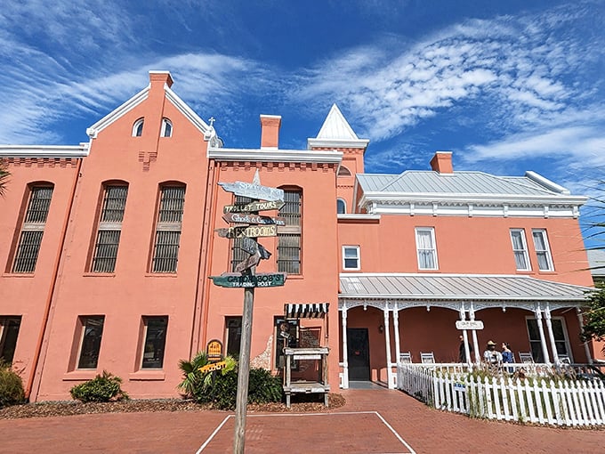 The salmon-pink facade of St. Augustine's Old Jail Museum stands as a masterpiece of architectural misdirection&mdash;"Come for the incarceration, stay for the Victorian charm!"