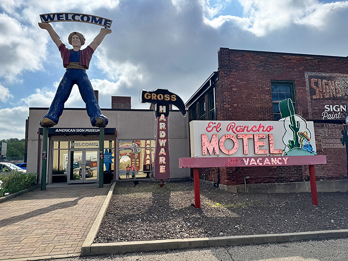 The ultimate welcome committee! A giant fiberglass "muffler man" holds court outside the American Sign Museum, promising vintage delights inside.