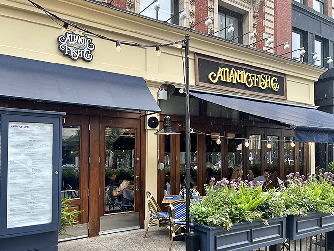The golden facade of Atlantic Fish Company stands out on Boylston Street like a beacon for seafood lovers&mdash;nautical elegance in Boston's Back Bay.