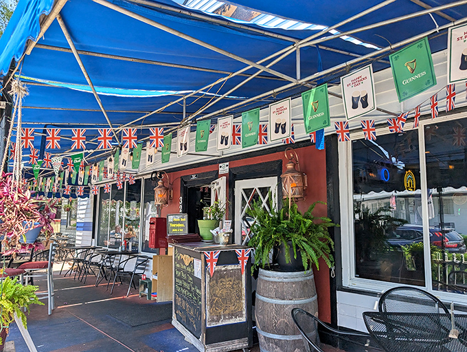 The blue awning and festive British bunting create a cheerful oasis that screams "England called, they want their pub back!"