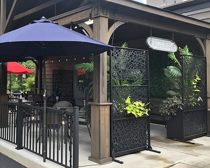 The outdoor patio at Momma Spriggs beckons with its stylish privacy screens and lush greenery&mdash;an urban oasis where food and conversation flow equally well.