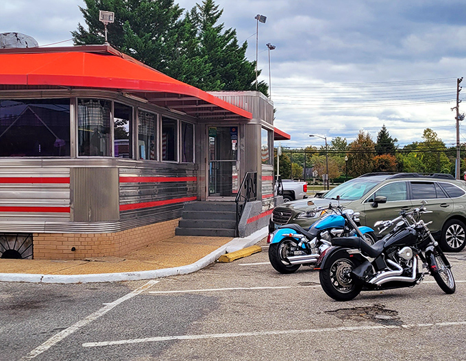 The classic stainless steel exterior with vibrant red trim stands as a time capsule on wheels, beckoning hungry travelers with promises of comfort food and nostalgia.