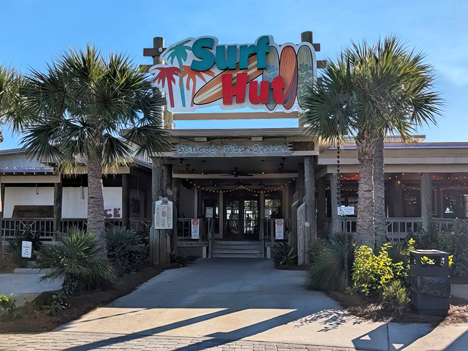 The entrance to seafood paradise isn't pearly gates, but a weathered wooden sign flanked by palm trees. Beach vibes begin here.