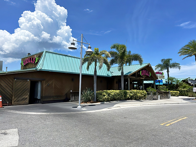 Florida architecture at its finest – where palm trees stand guard and the promise of fresh seafood waits just beyond those wooden doors.