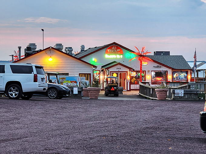 As dusk settles, Tim's II transforms into a neon-lit beacon for hungry travelers. The palm tree's glow promises tropical flavors in Virginia waters.