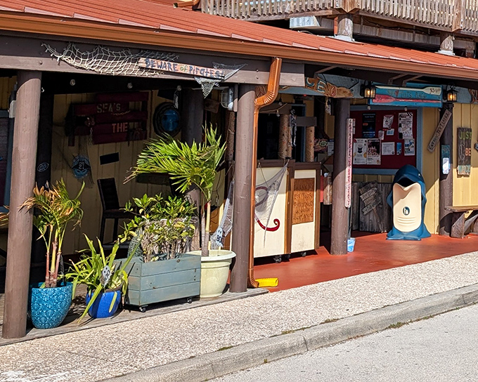 The iconic red cursive sign welcomes seafood lovers like a beacon of deliciousness. Rusty's weathered wooden deck promises authentic coastal experiences without pretension.