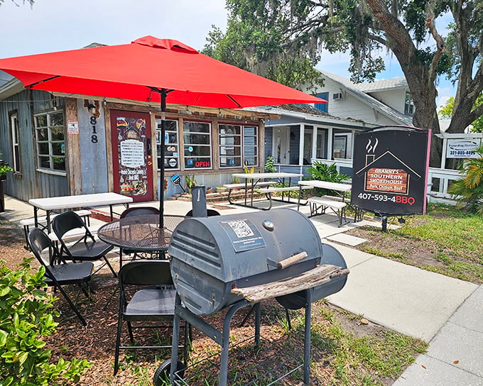 That red umbrella outside promises shade, but the real shelter from hunger waits inside with the smoker.