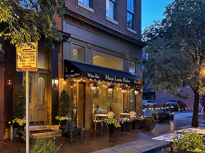The charming exterior of Marie Louise Bistro beckons like a Parisian daydream on a Baltimore corner. Those sidewalk tables? Pure European magic at twilight.