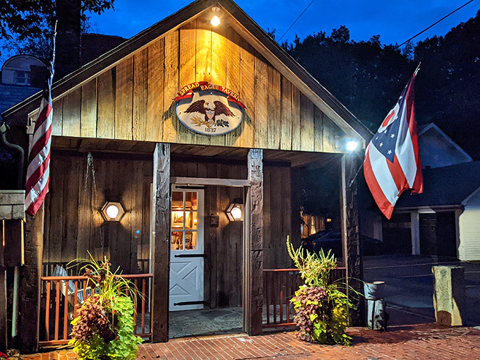 The historic facade of Spread Eagle Tavern welcomes visitors with rustic charm, a brick courtyard, and the promise of culinary time travel in rural Hanoverton.