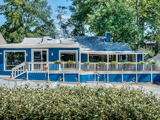 The blue clapboard exterior of Buttermilk Kitchen stands out like a cheerful beacon, promising breakfast salvation with its welcoming porch and sunny disposition.
