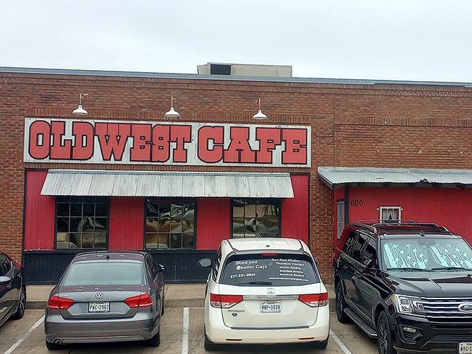 The brick facade and bold red signage of Old West Cafe stands as a beacon of breakfast promise in Grapevine, no fancy frills needed.
