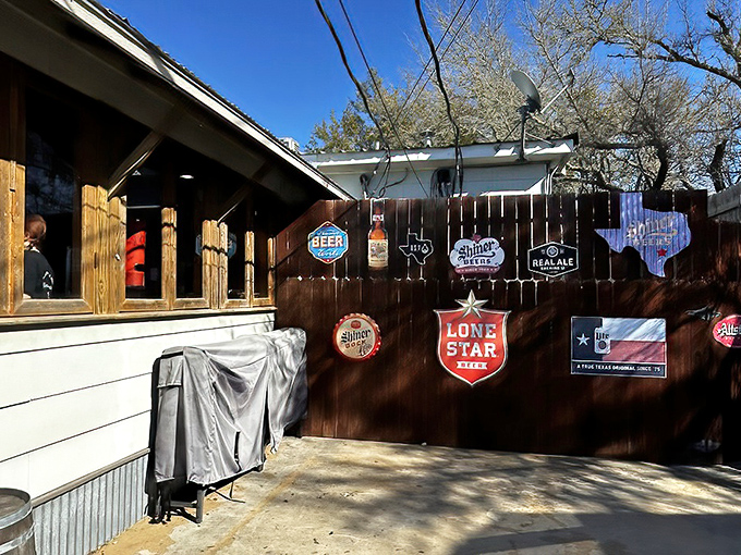 Texas beer pride adorns the outdoor area, where Lone Star and Shiner signs create the perfect backdrop for post-burger relaxation.