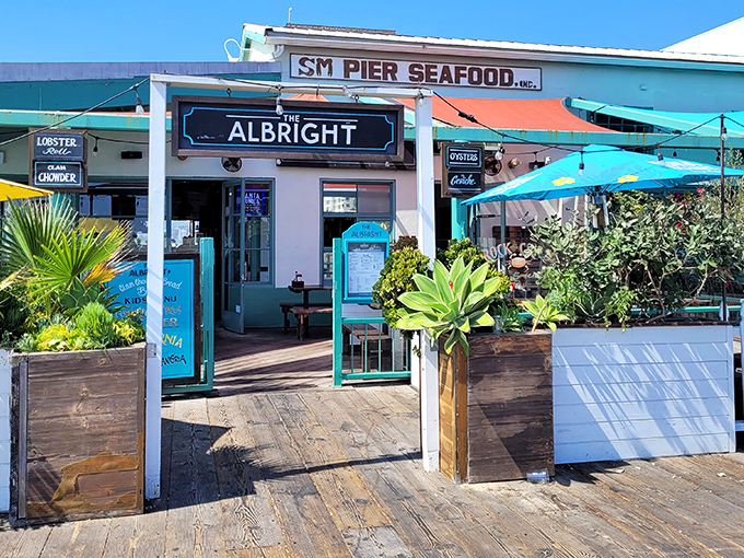 The aqua-trimmed exterior of The Albright beckons like a siren song on Santa Monica Pier, promising seafood treasures within its weathered wooden walls.