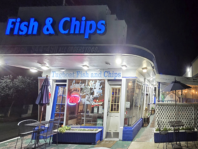 Tugboat's iconic blue neon sign beckons seafood lovers even after dark, promising golden, crispy treasures within this Carmichael gem.