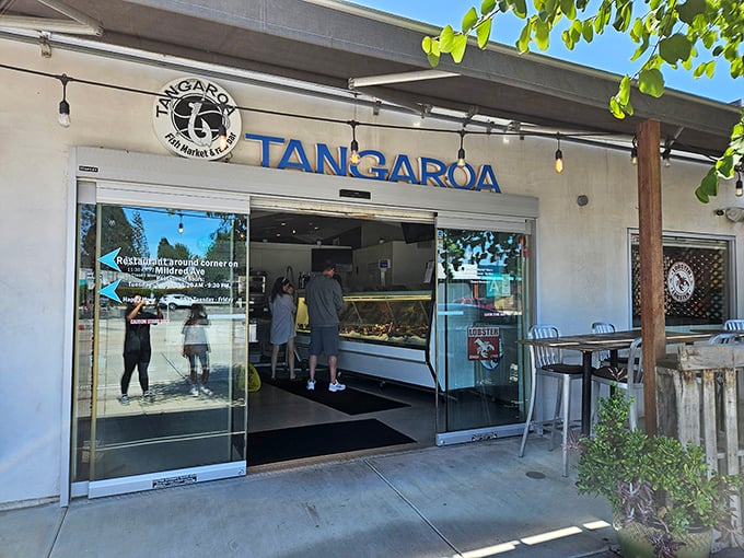 The unassuming entrance to Tangaroa beckons like a secret whispered among friends – no flashy neon, just the promise of seafood treasures within.