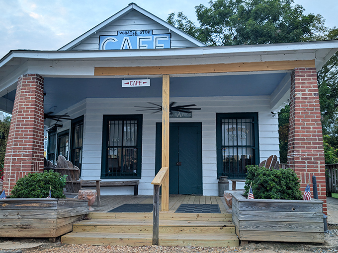 The quintessential Southern storefront that whispers, "Slow down, honey." White clapboard, brick columns, and that iconic blue sign promising good food and fair prices.