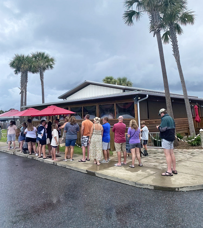 Stewby's Seafood Shanty stands like a beacon of Old Florida charm, palm trees standing guard over this unassuming treasure that promises seafood nirvana.