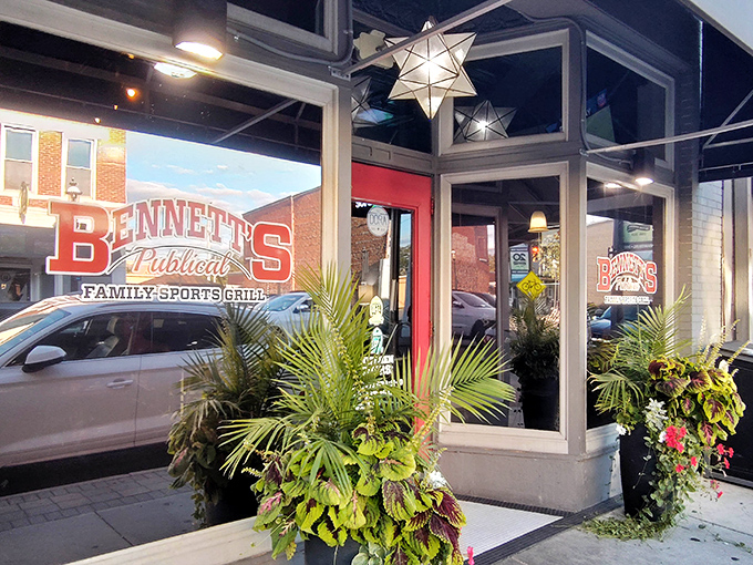 The inviting storefront of Bennett's Publical beckons with its bold red signage, star-shaped pendant lights, and lush greenery. A culinary oasis in downtown Miamisburg.