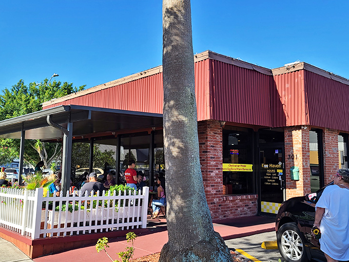 Morning sunshine bathes the outdoor patio where locals gather, a telltale sign you've found a genuine Florida breakfast institution rather than a tourist trap.