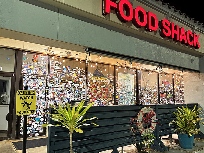 The sticker-covered windows of Food Shack tell a story before you even walk in&mdash;each one a testament to a happy diner's journey.