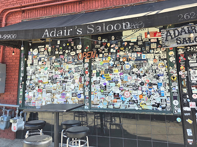 Sticker shock takes on new meaning at Adair's entrance, where decades of patron-applied memorabilia create a visual history more authentic than any designer could dream up.