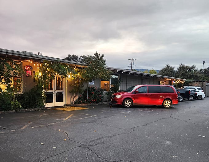 The unassuming exterior of Longhouse Restaurant proves once again that culinary treasures often hide in plain sight, string lights adding a touch of warmth.