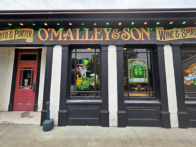 The historic façade of O'Malley's Pub beckons with old-world charm, stained glass, and the promise of underground adventures waiting just beyond that red door.