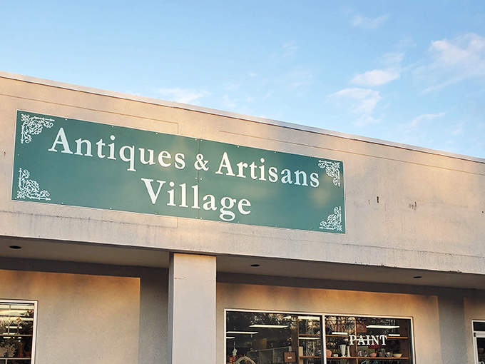 The welcoming green sign of Antiques & Artisans Village promises treasure hunting adventures beneath South Carolina skies. A portal to the past awaits!