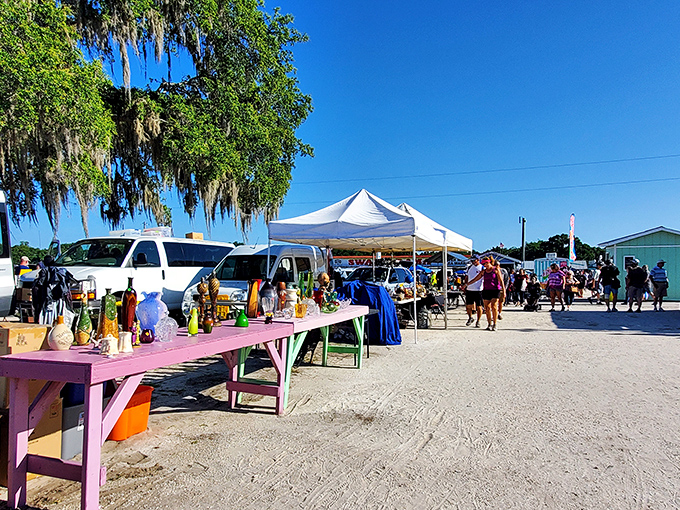 Treasure hunting in action! Tables laden with curiosities stretch into the distance while shoppers scan for that perfect find under Florida's brilliant blue sky.