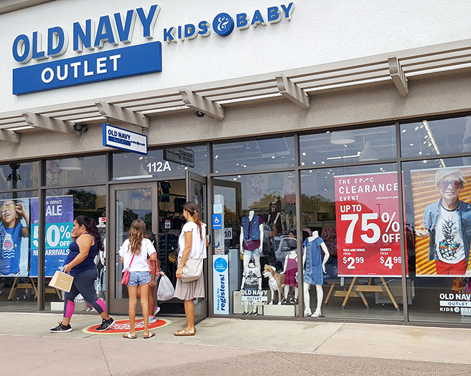 Bargain hunters line up outside Old Navy Outlet Kids & Baby, where deep discounts and clearance deals make every shopping trip feel like a treasure hunt.