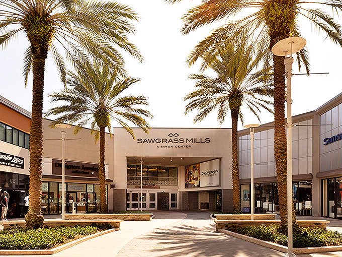 Palm trees standing like elegant sentinels at the entrance &ndash; Florida's way of saying "prepare your credit cards for what lies beyond."