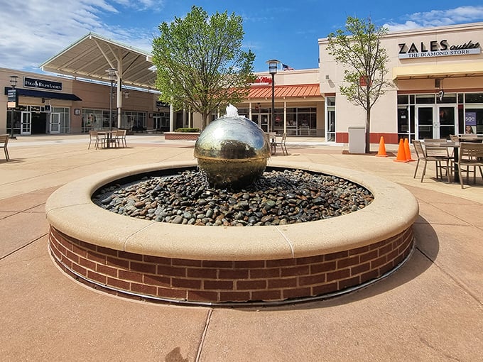 The iconic sphere fountain serves as both meeting point and meditation spot. "I'll meet you at the giant ball" is practically the outlet mall's official language.