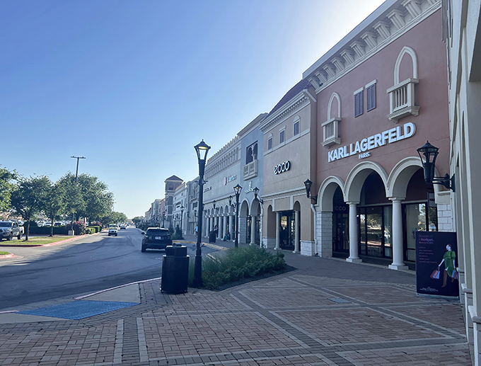 Mediterranean elegance meets Texas-sized shopping at San Marcos Premium Outlets, where Karl Lagerfeld and sunshine create the perfect retail therapy backdrop.