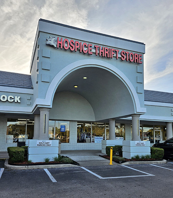 The iconic archway entrance beckons bargain hunters like a retail Narnia portal. Blue skies above promise good fortune within.