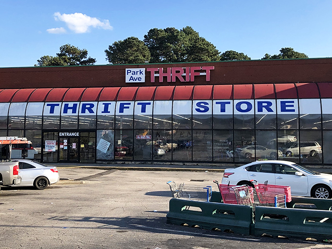The iconic red awning of Park Avenue Thrift beckons bargain hunters like a retail lighthouse guiding ships full of empty wallets safely to shore.