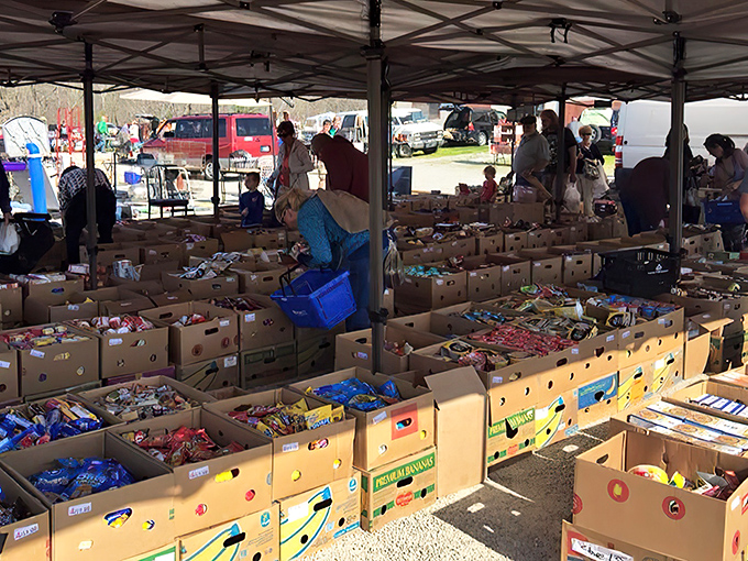Treasure hunters examine tables laden with tools and gadgets. One man's junk becomes another's essential garage addition at this sprawling marketplace.