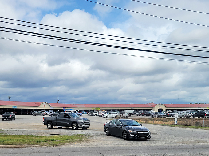 The sprawling exterior of Barnyard Flea Market beckons treasure hunters with its no-frills charm and packed parking lot&mdash;weekend adventures await inside!