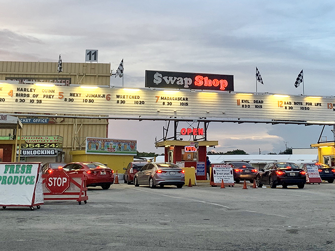 The iconic Swap Shop marquee doubles as a drive-in movie theater by night, proving that in Florida, even bargain hunting comes with a show.