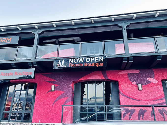 The pink palace of bargains stands proudly against the desert mountains, like a flamingo promising treasures within its walls.